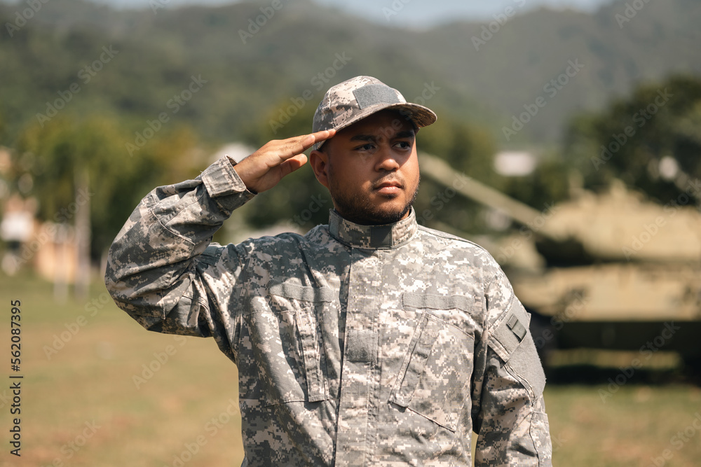Asian man special forces soldier saluting standing against on the field ...