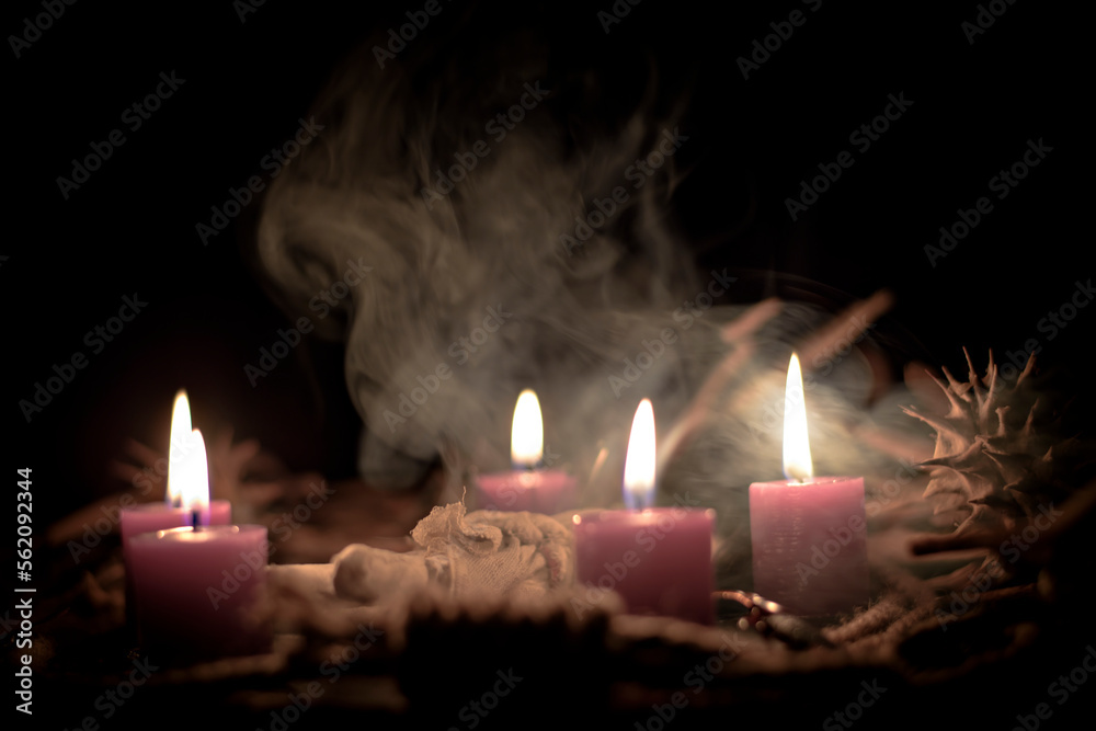 Voodoo doll, black candles, pentagram and old books on witch table ...