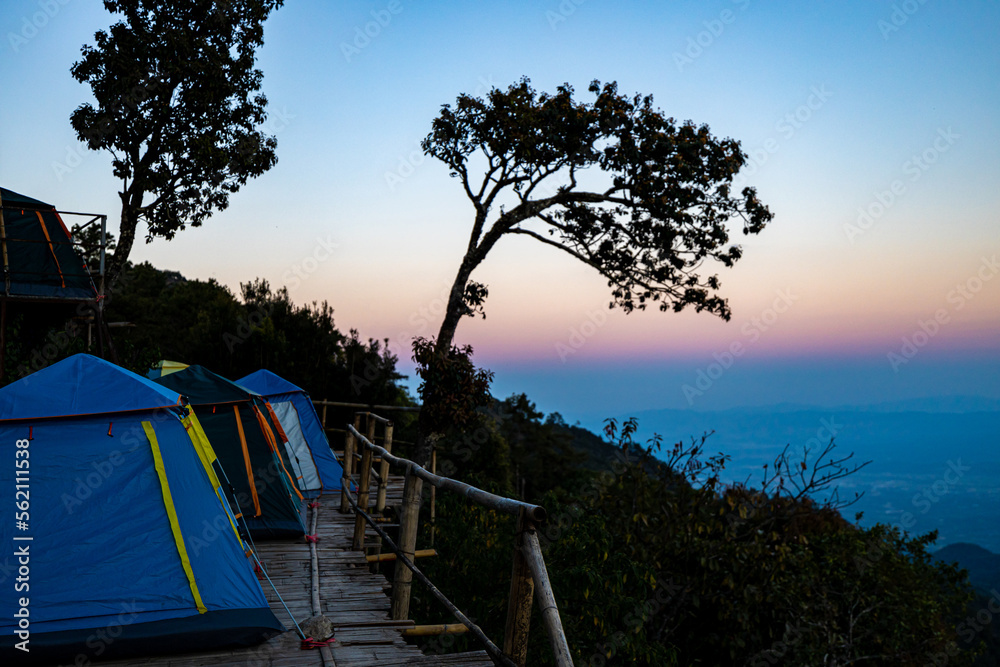 View of tents camping at the campsite in the woods with mountain range ...