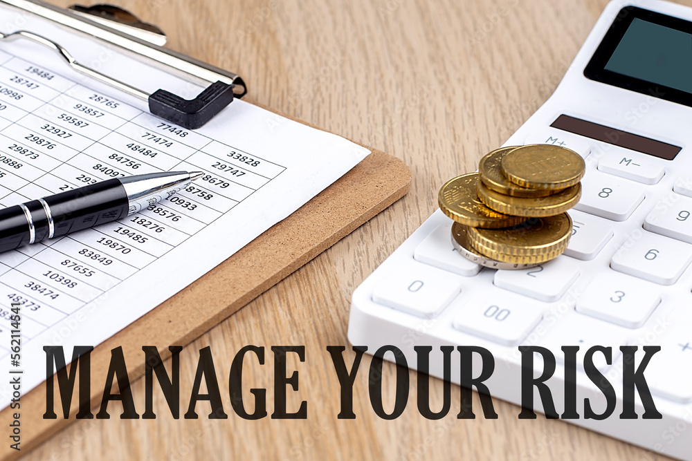MANAGE YOUR RISK text with chart and calculator and coins , business ...