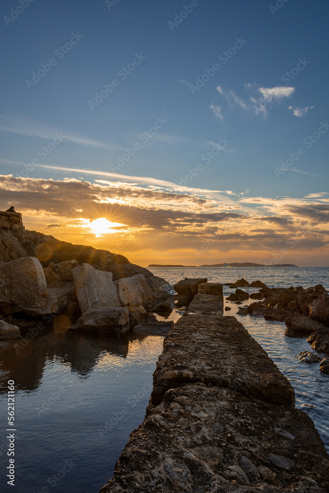 Logas sunset beach with sheer white cliffs in Peroulades village on ...