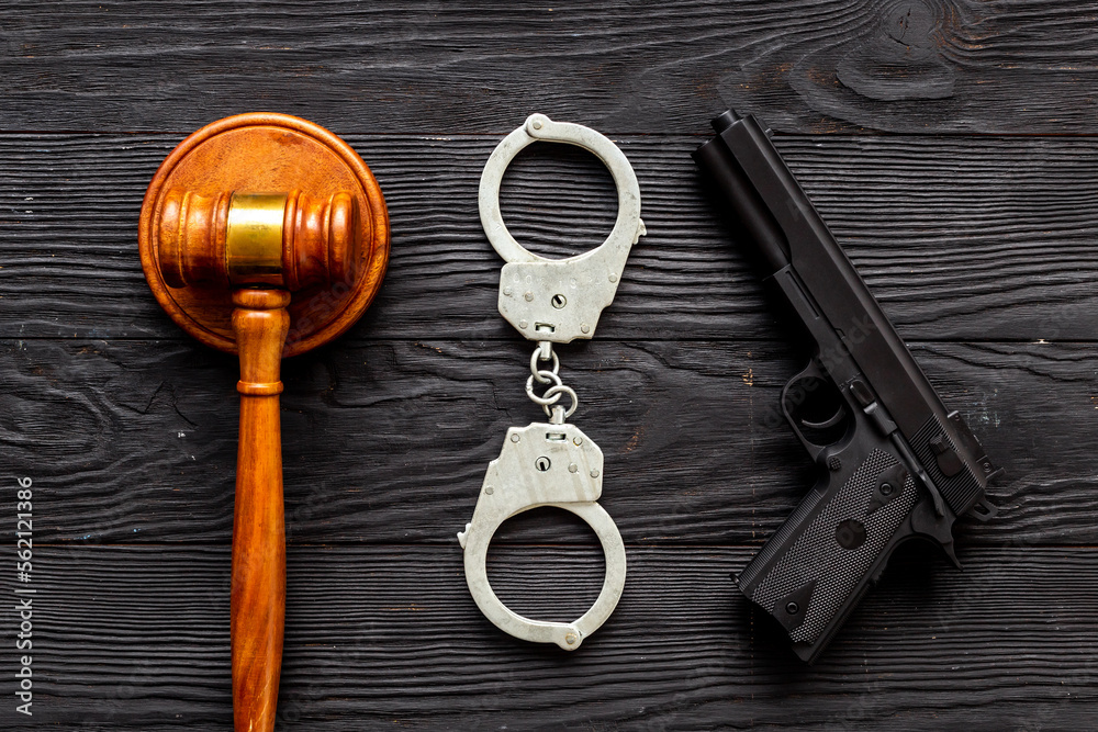 Hand gun weapon and judges gavel - gun law. Illegal use of weapons ...