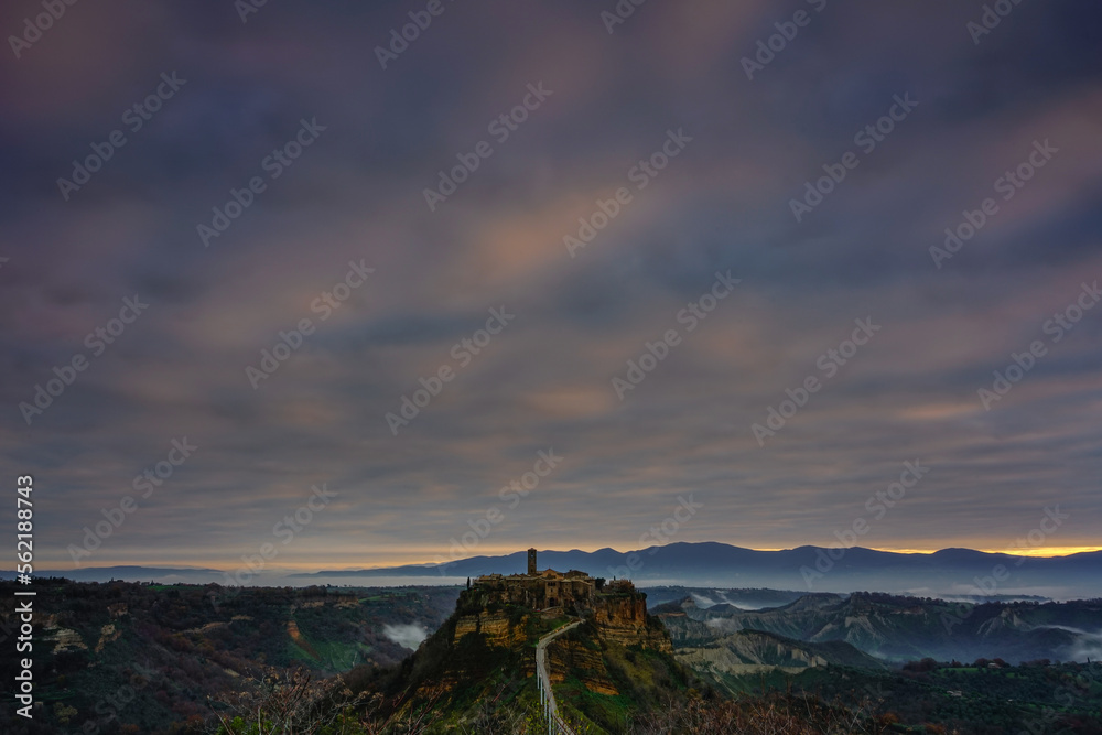 Clouds full of colors in a winter sunrise over Civita di Bagnoregio ...