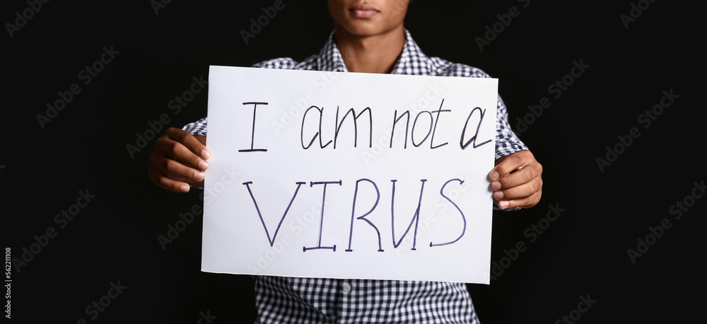 African-American teenage boy with poster on dark background. Stop ...