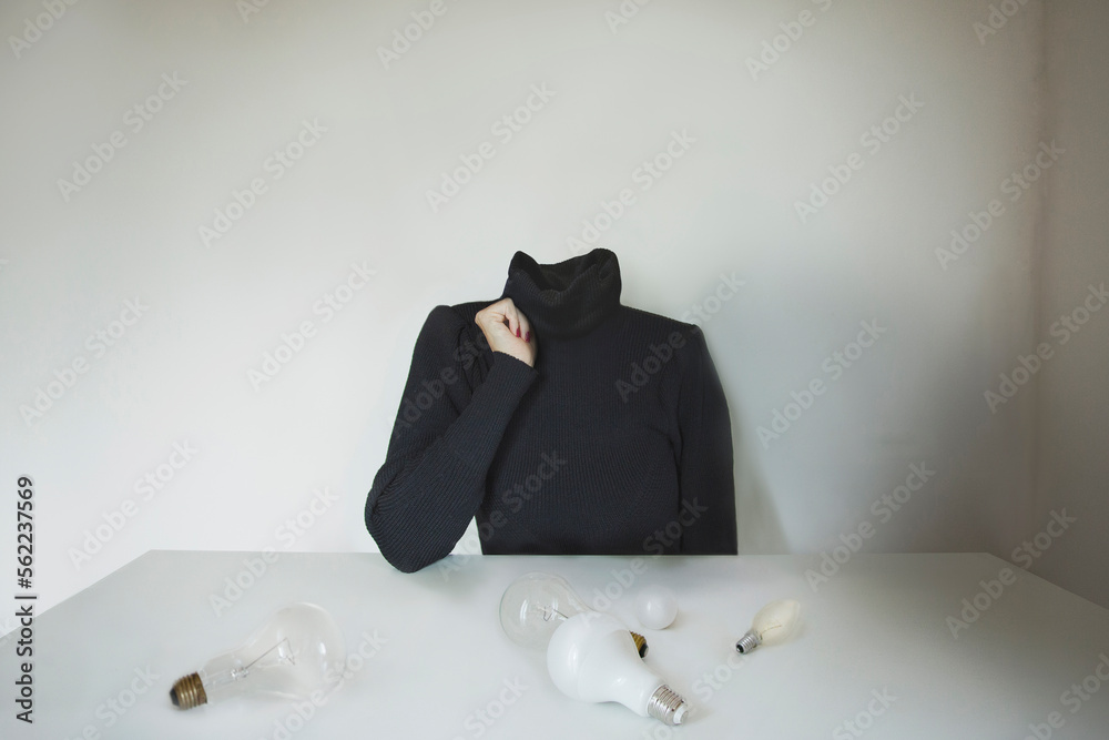 headless surreal person looks for the right light bulb for the most ...