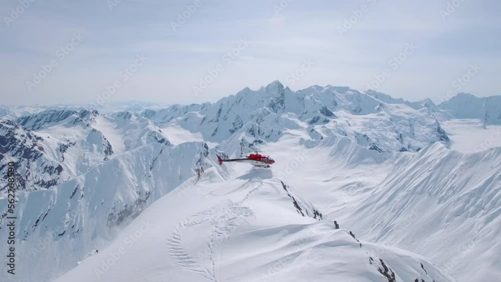 Heli-Skiing helicopter take-off from a snowy mountain in Alaska Stock ...