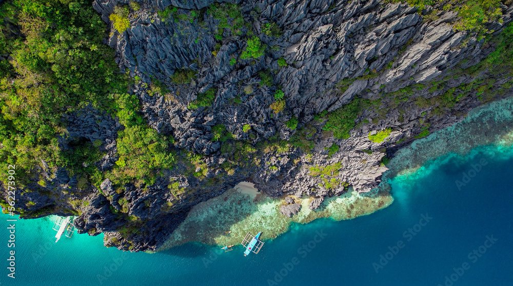 Aerial of Catamaran Below Cliffs In Crystal Clear Water In El Nido ...