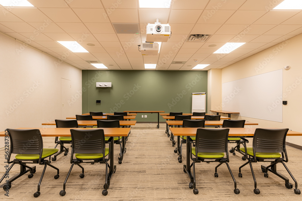Interior of an office training, meeting, conference room with desks ...