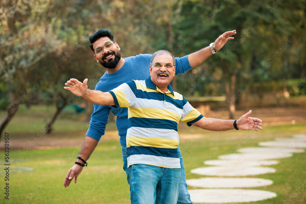 Old indian father with his young son spending time at park. Stock Photo ...