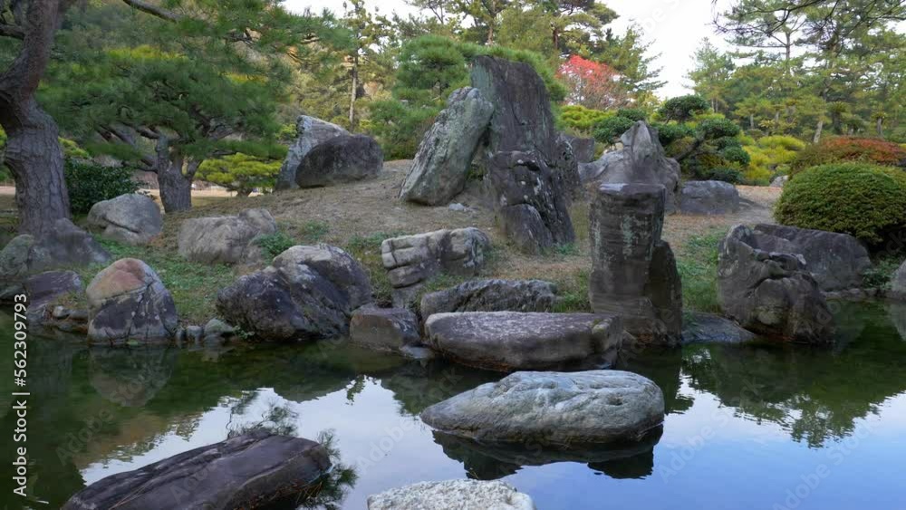 traditional Japanese rock garden with stone bridge and scenic ...