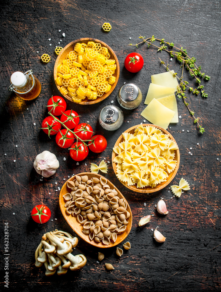Different types of raw paste with thyme, tomatoes and mushrooms. Stock ...