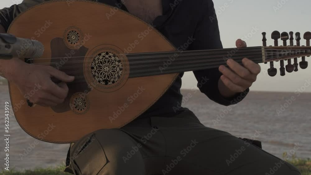 A handheld footage of a male musician while performing live using his ...