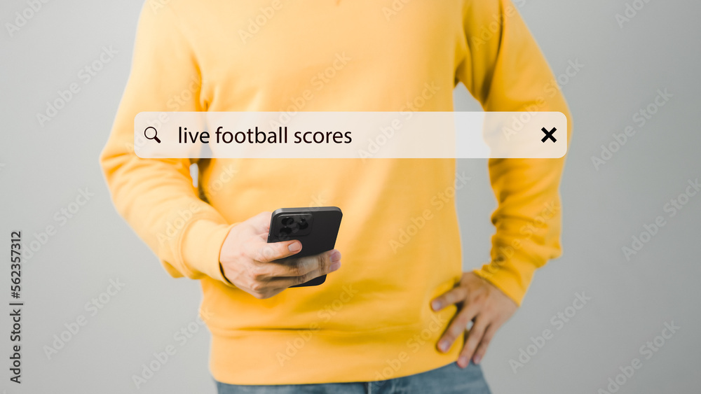 Football fan's holding smartphone for search live football scores ...