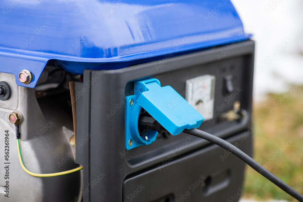 Electrical plug in the outlet of generator, outdoors, close up. Concept ...