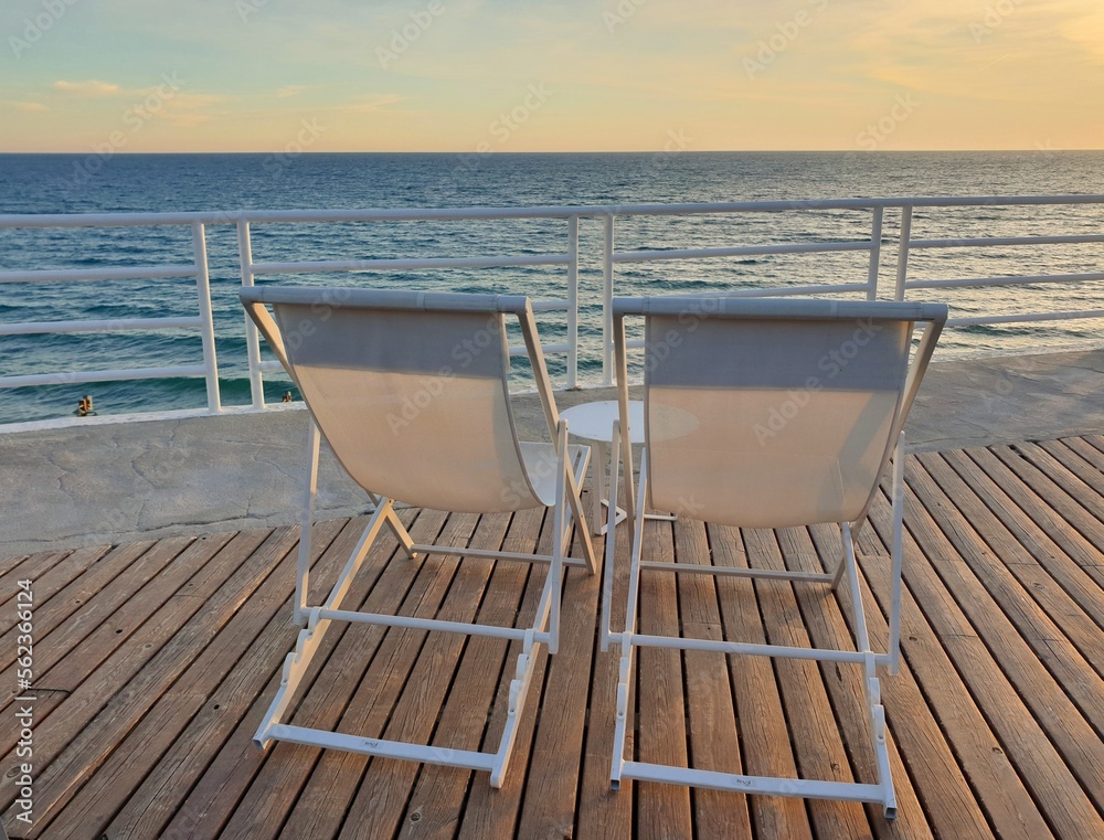 Sun loungers with a sea view and sunset. Relaxation with a sea view ...