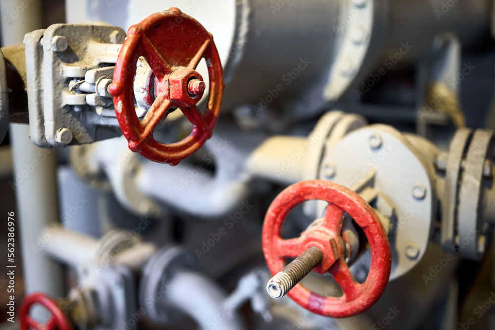 Two retro design industrial butterfly valves with red handwheels over ...