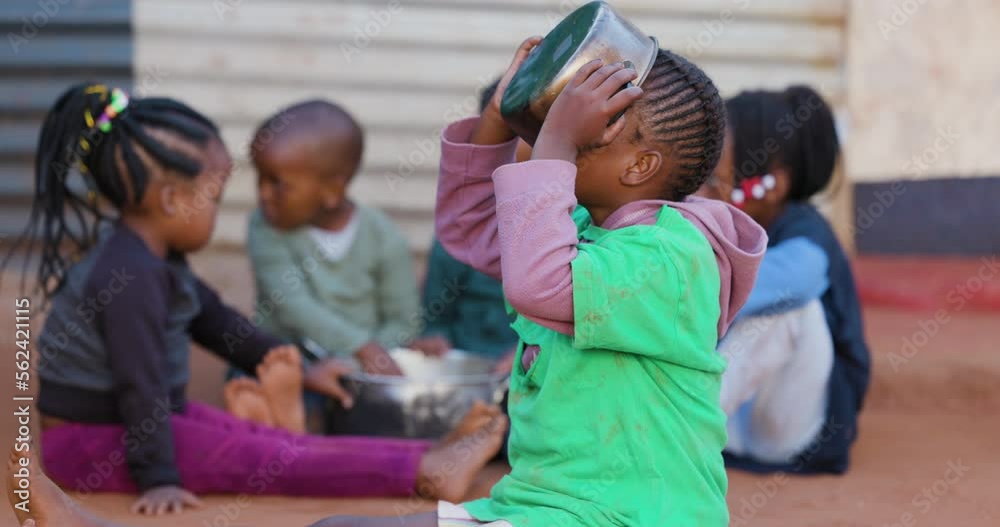 Poverty in Africa. Young starving Black African girl eating maize from ...