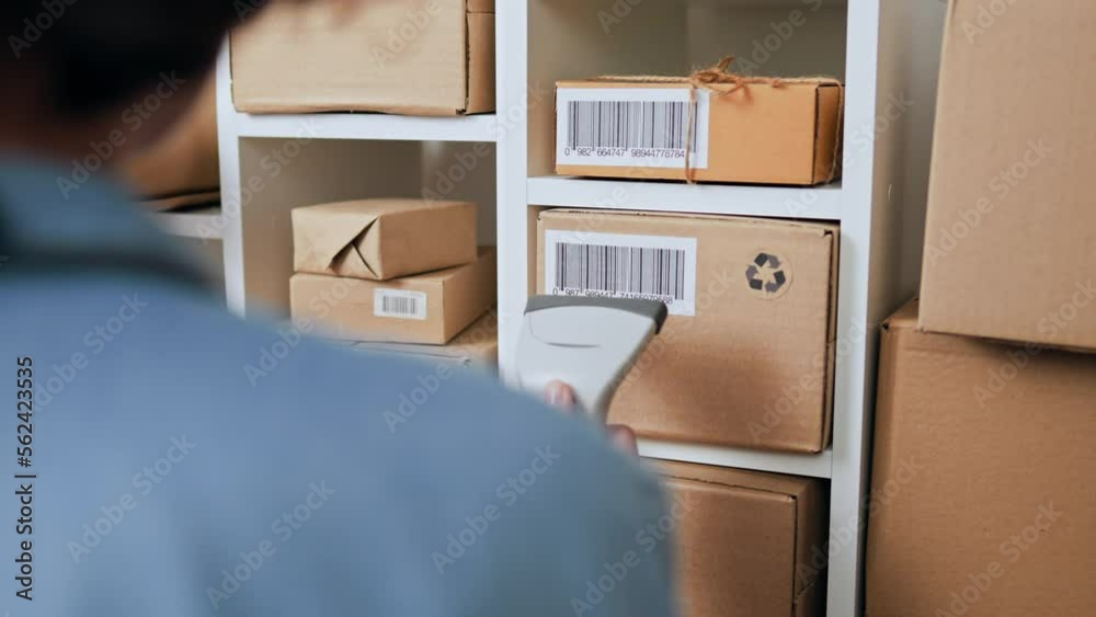 The process of scanning cargo parcels using a barcode scanner the red beam scanner, a medium ...