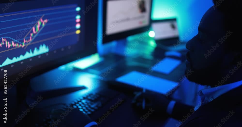 African trader working inside office at night time - Trading and ...