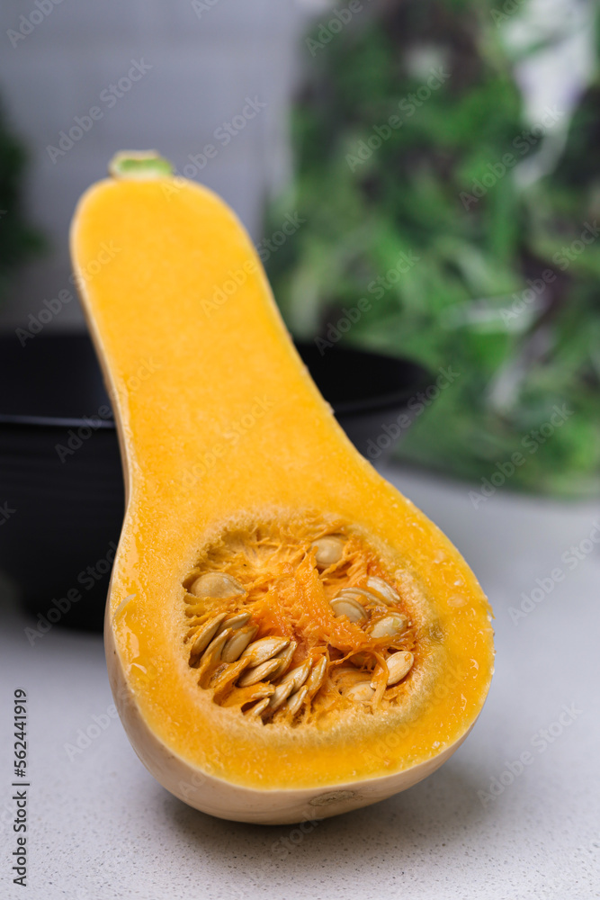 Butternut squash sliced in half on white background, front view shot of ...