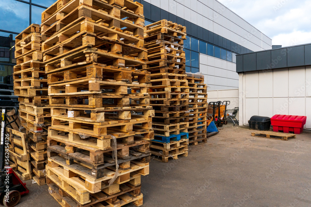 A stack of wooden pallets in an internal warehouse. An outdoor pallet ...