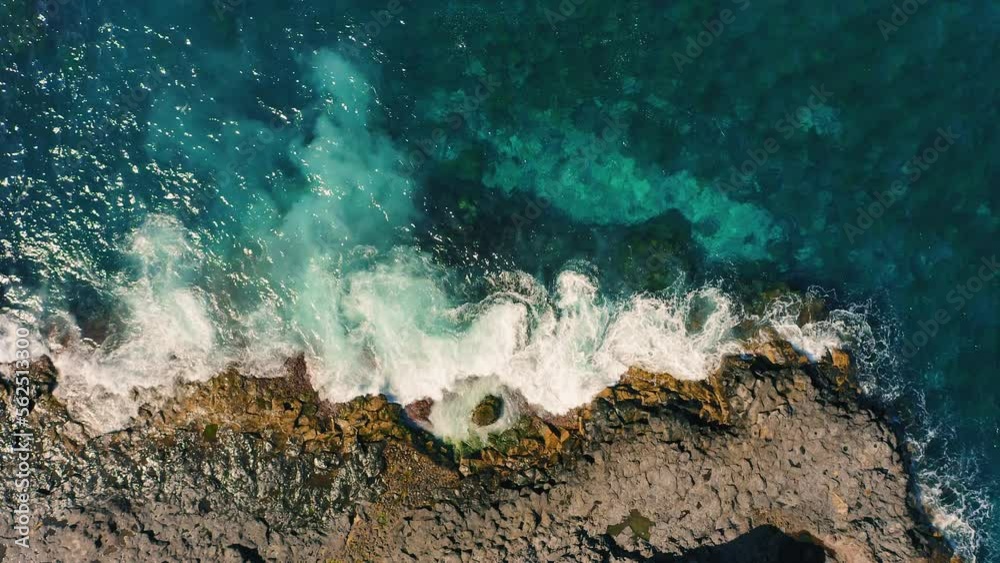 Ocean water washing volcanic rocky rough beach and waves foam ...