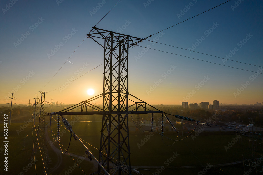High voltage electricity pylon at golden hour background. International ...
