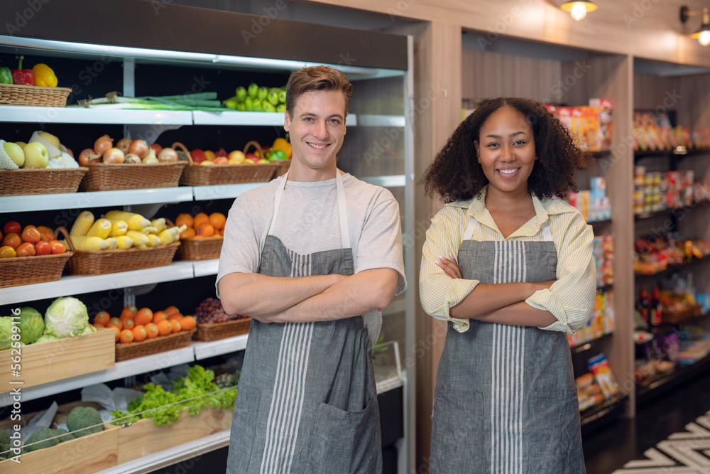 American woman grocery working in supermarket with fruit and vegetable ...