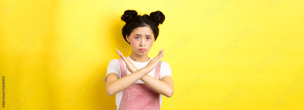 Sad girl begging to stop, frowning uspet and showing cross sign, say no ...