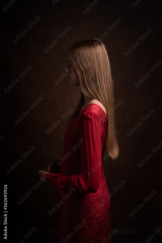 mysterious portrait of woman in the shadows wearing red dress in ...