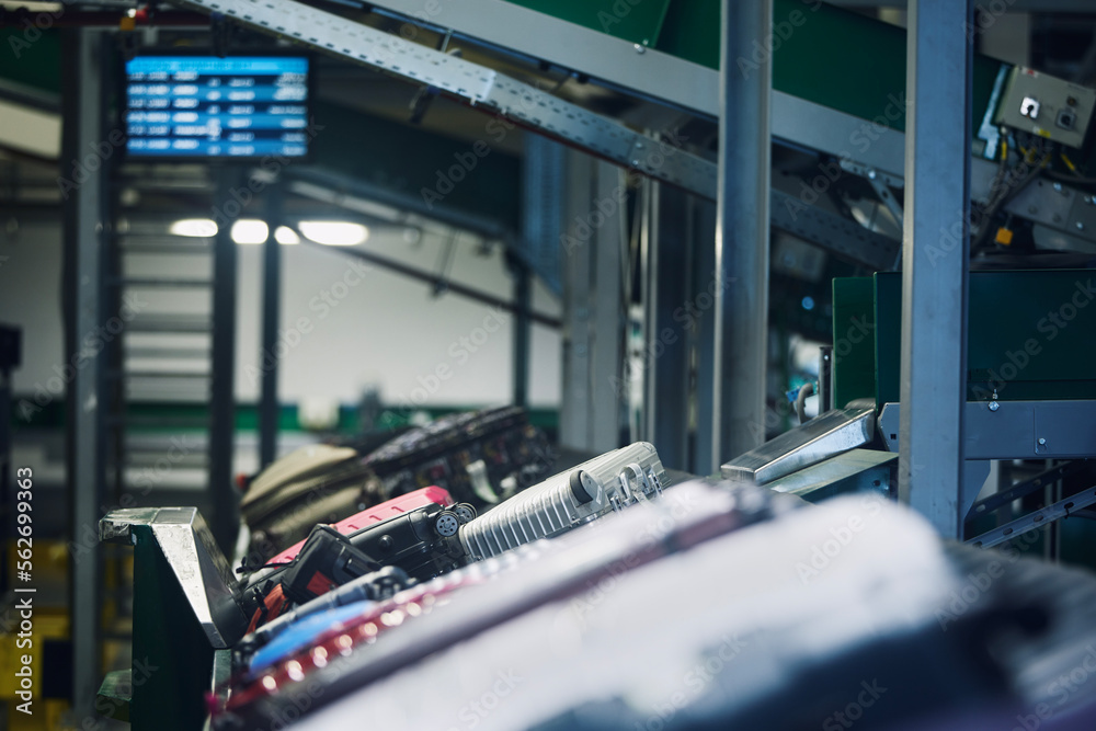 Lot of luggage on conveyor belt. Baggage sorting at airport. Traveling ...