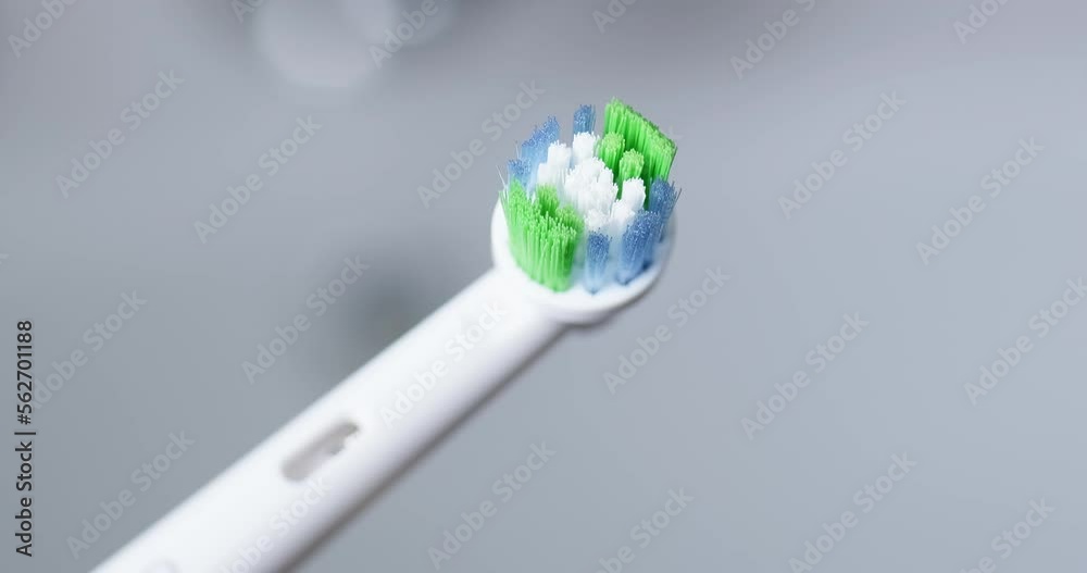 Toothpaste put on electric toothbrush with new head. View of ultrasonic ...