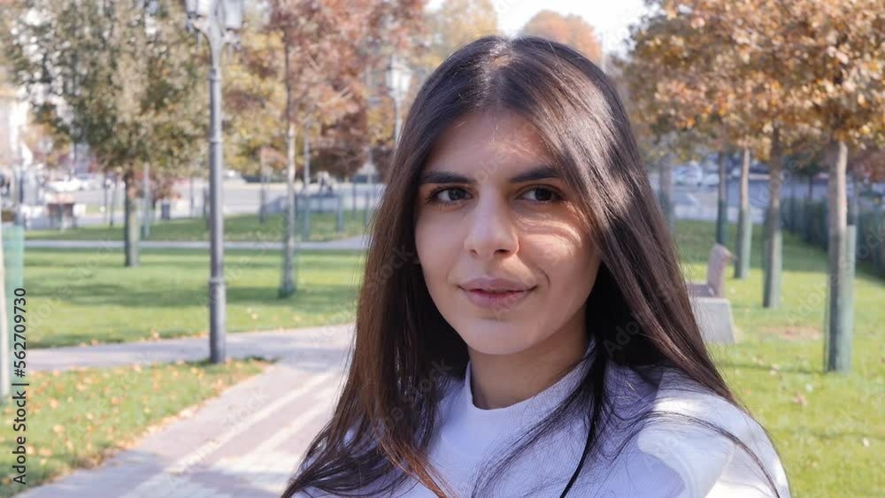 Portrait of a cute young woman of Middle Eastern nationality with black ...