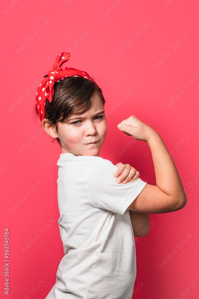 Cute powerful little girl showing muscles Stock Photo | Adobe Stock