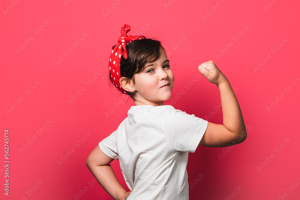 Cute powerful little girl showing muscles Stock Photo | Adobe Stock