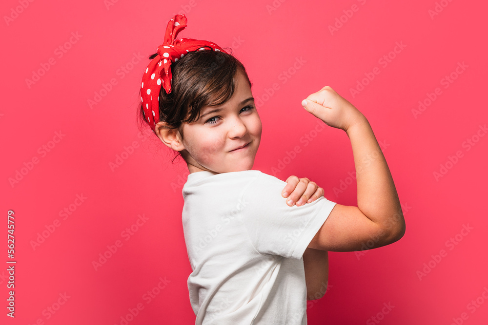Cute powerful little girl showing muscles Stock Photo | Adobe Stock