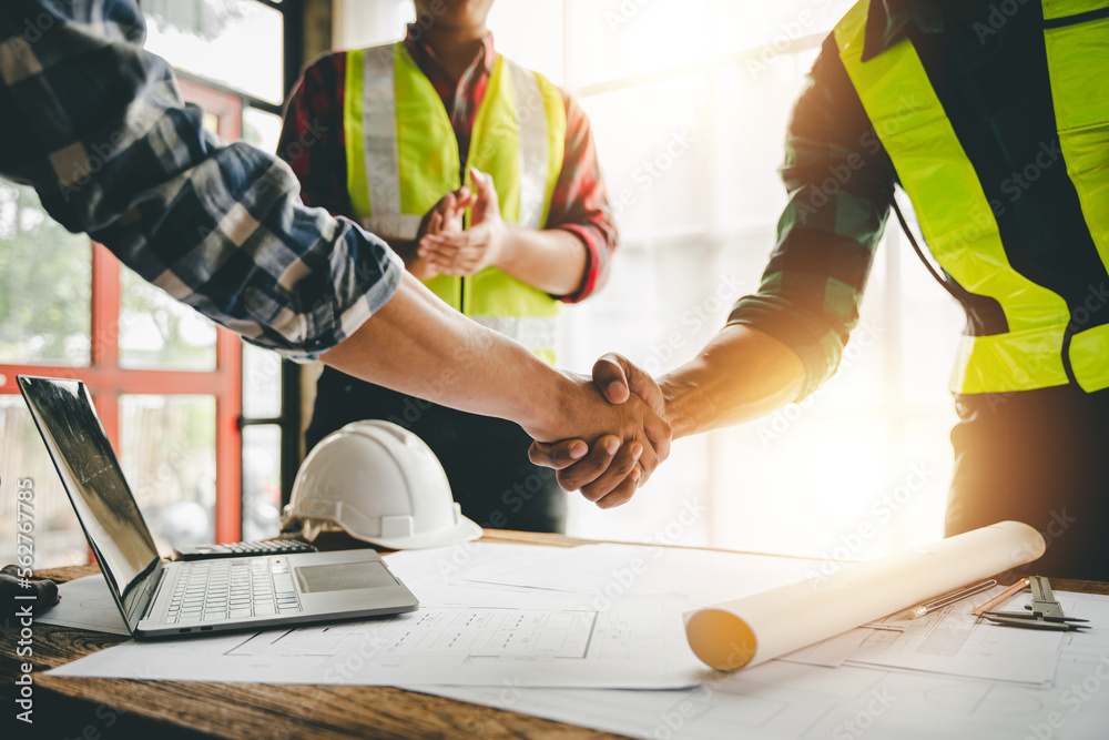 engineering team shaking hands start planning for architecture Engineer sketching construction ...