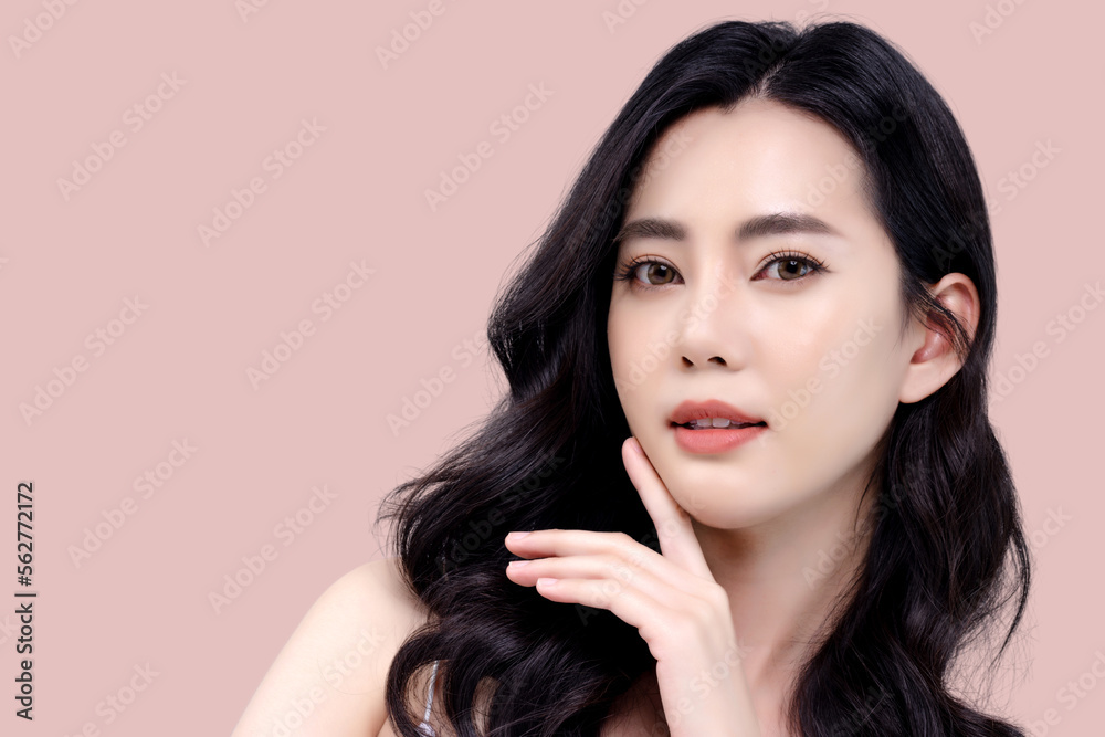 Beautiful Asian girl with long and shiny wavy hair isolated on pink ...
