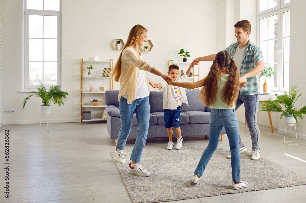 Happy family with two children are playing leading a round dance at ...