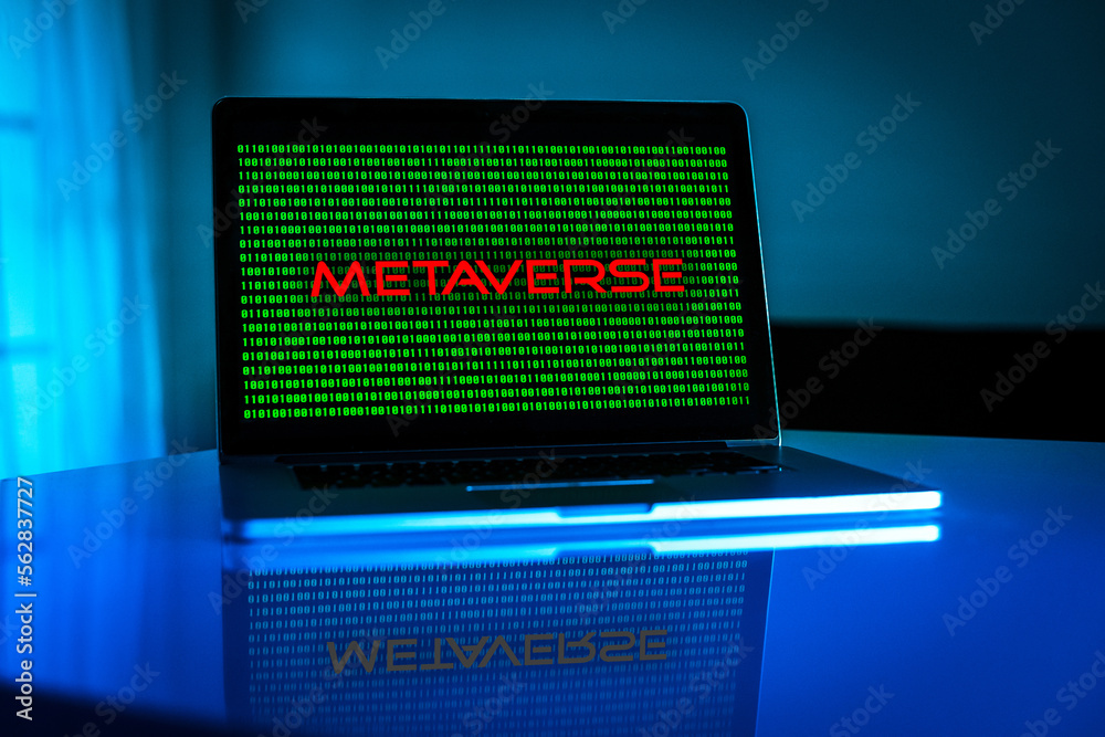 Foto de Computer laptop on desktop display code and word "metaverse ...