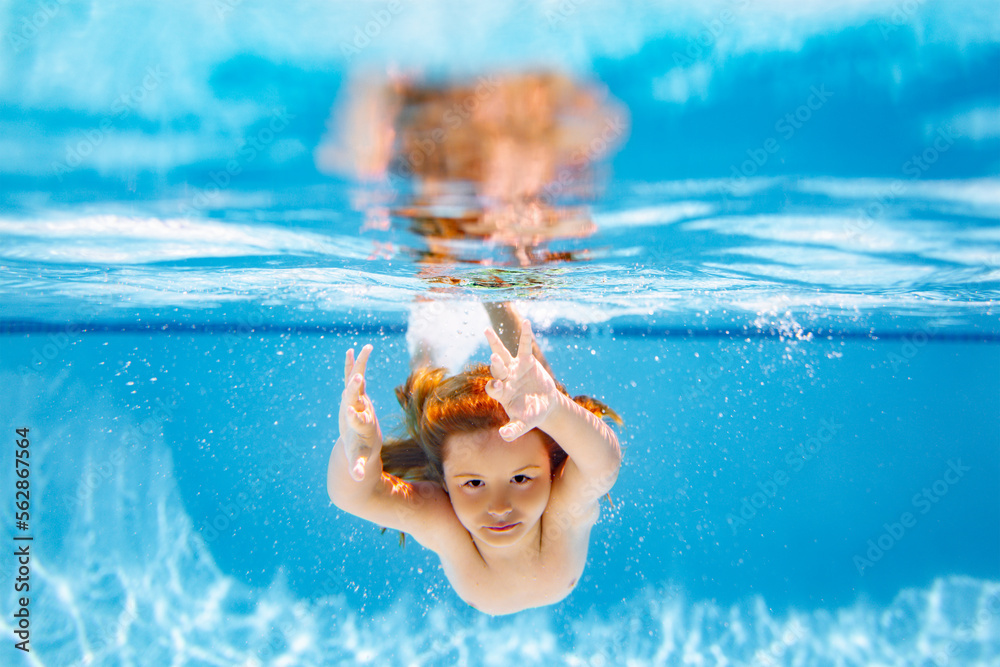 Kid swimming underwater on the beach on sea in summer. Blue ocean water ...