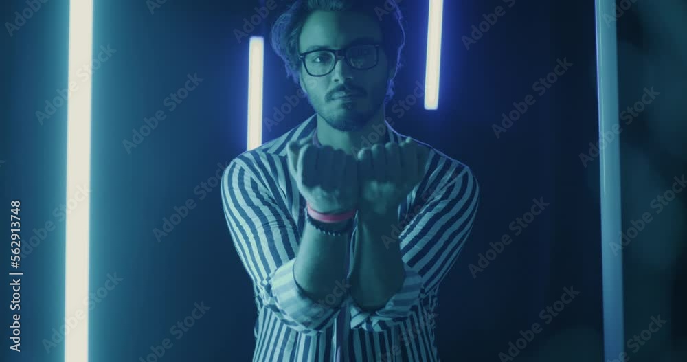 Portrait of sad young man stretching arms for handcuffs during arrest ...