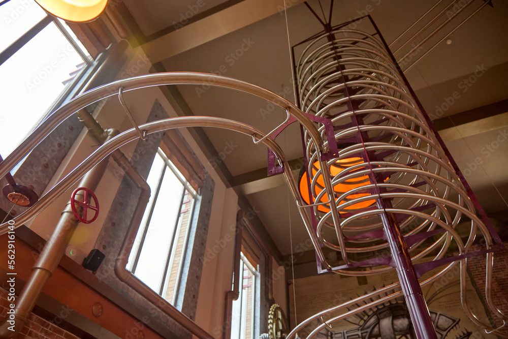 Automatic delivery of orders by metal spiral staircase in a modern ...