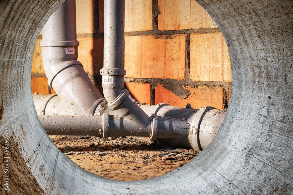 Sewer pipes in home basement. System of gray sanitary pipes when ...