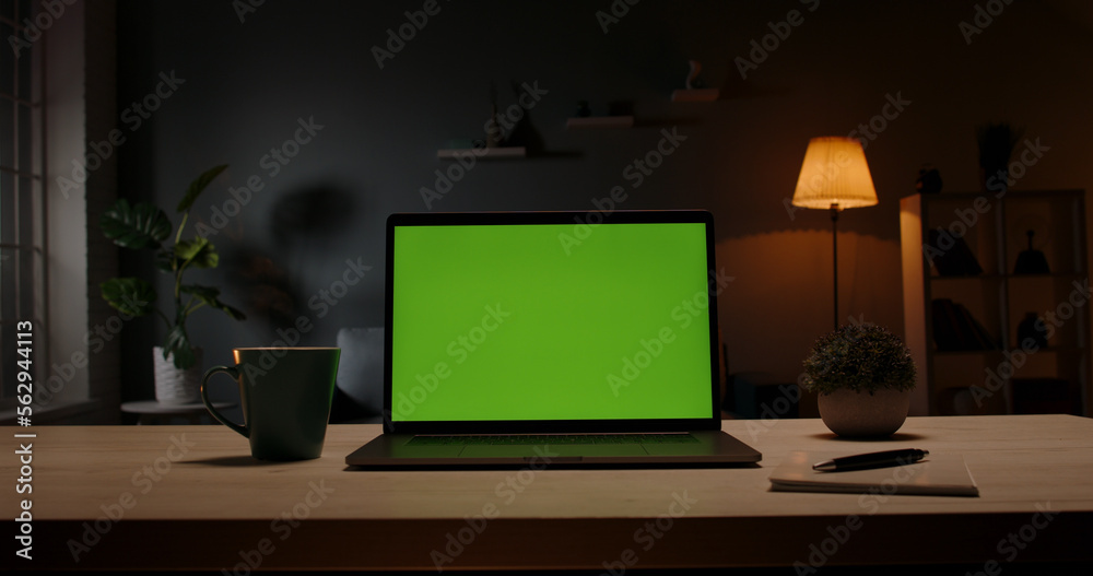 Chroma key green screen template - a laptop computer on a desk in cozy ...