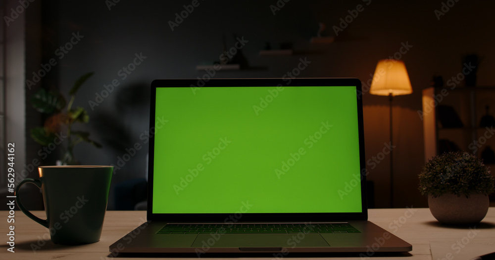 green screen template - a laptop computer on a desk in cozy living room ...