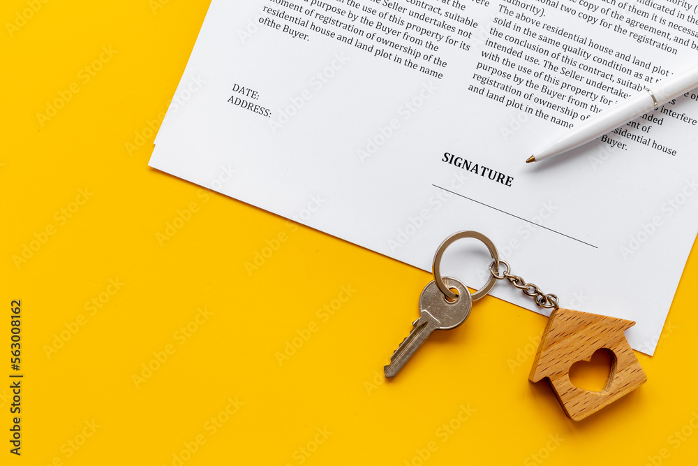 Signing a house purchase agreement with house shaped keychain Stock ...