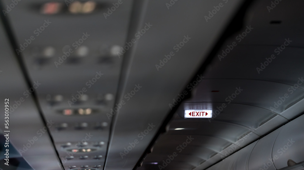 Exit sign in passenger airplane. Emergency exit sign on airplane. Exit ... Exit sign in passenger airplane. Emergency exit sign on airplane. Exit ...