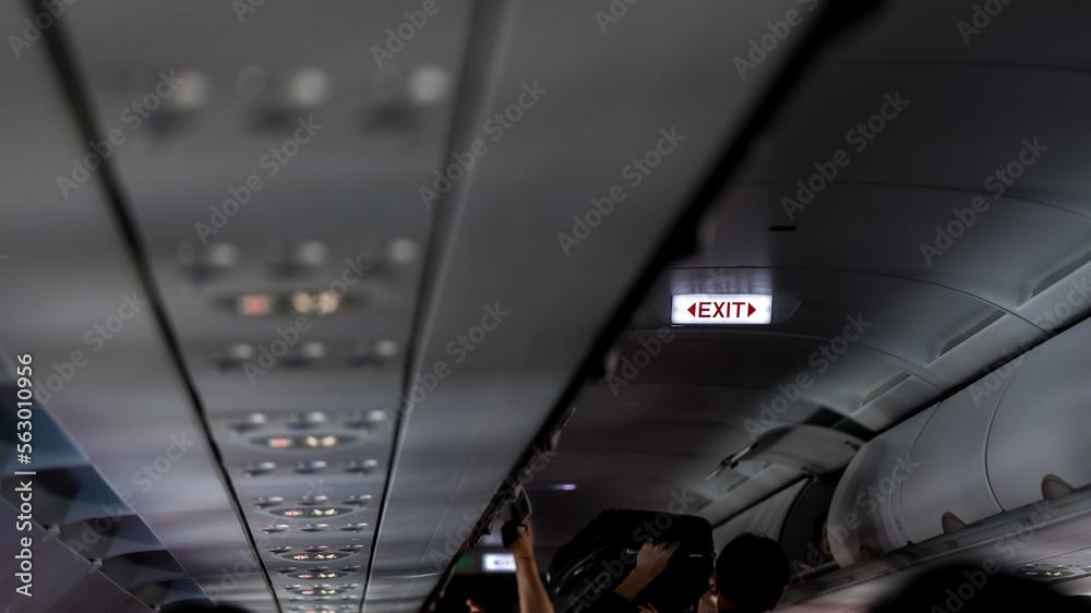 Exit sign in passenger airplane. Emergency exit sign on airplane. Exit ...