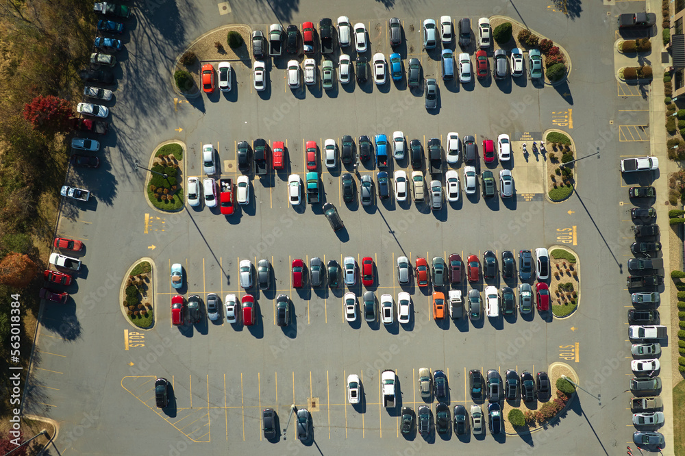 Aerial view of large parking lot with many parked colorful cars ...